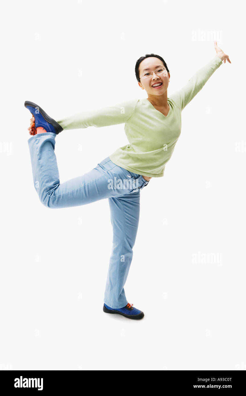 Portrait of Asian woman holding leg up Stock Photo - Alamy