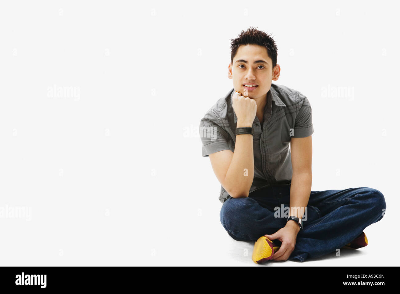 Portrait of Pacific Islander man sitting cross legged Stock Photo - Alamy