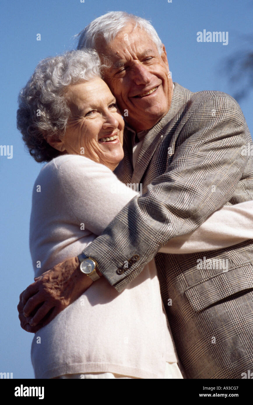 Side profile of a senior couple embracing each other Stock Photo - Alamy