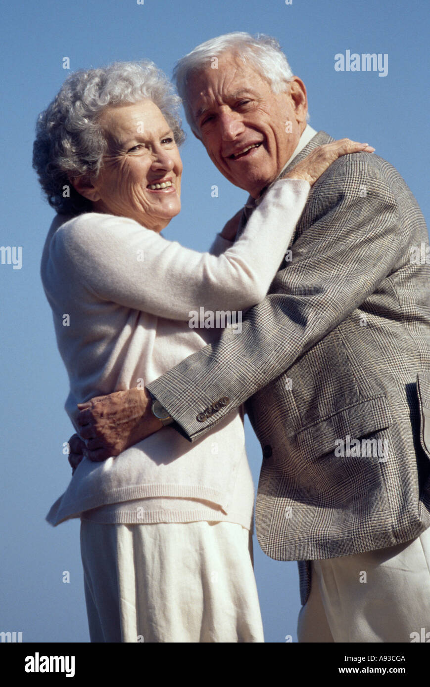 Side profile of a senior couple embracing each other Stock Photo - Alamy