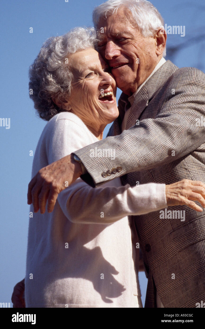 Side profile of a senior couple embracing each other Stock Photo - Alamy