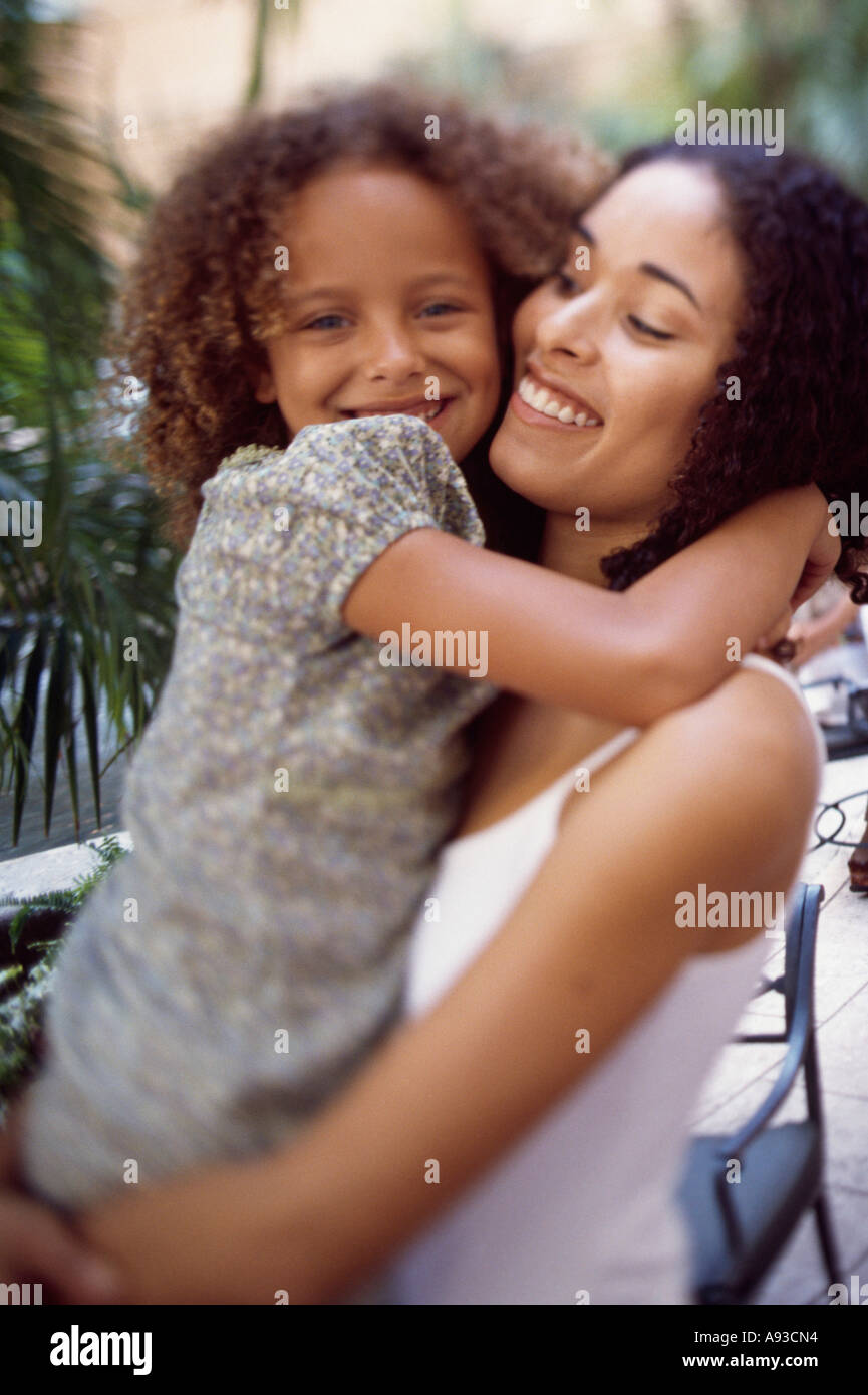 Side profile of a daughter hugging her mother Stock Photo - Alamy