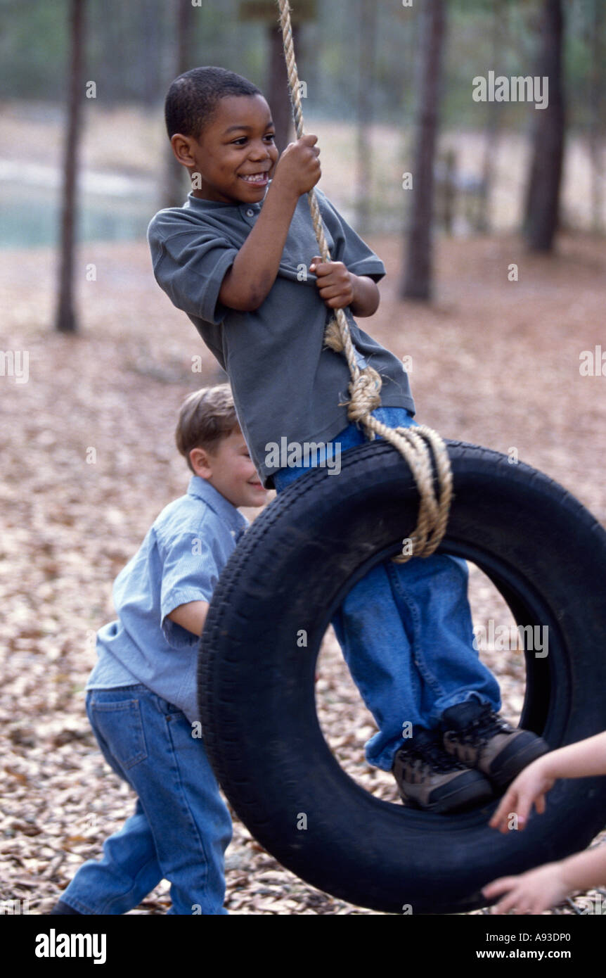Two boys playing on swing hi-res stock photography and images - Alamy