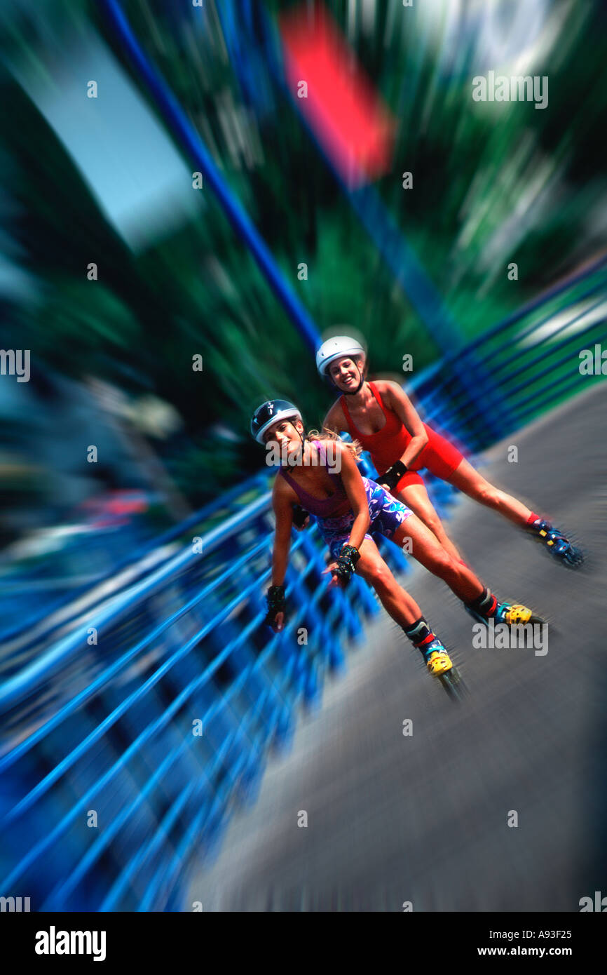 Attractive young women rollerblading outdoors Stock Photo - Alamy