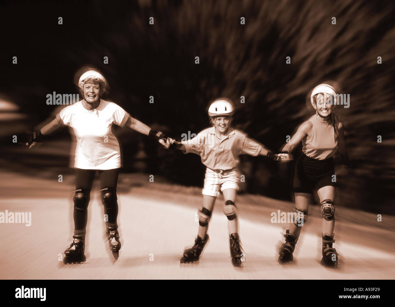Three generations of women rollerblading together Stock Photo - Alamy