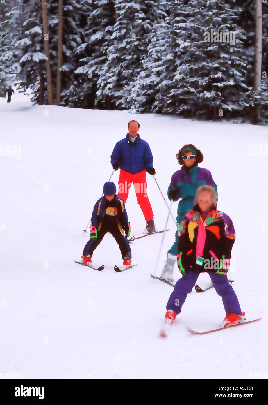 Attractive family skiing together Stock Photo - Alamy