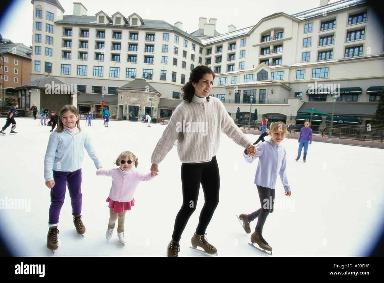Mother ice skating with her three daughters Stock Photo - Alamy