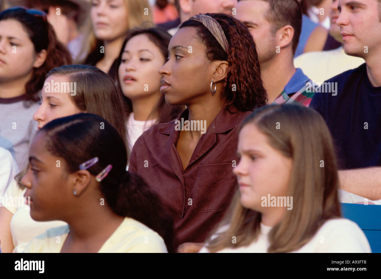 Spectators sitting in a stadium looking bored Stock Photo - Alamy