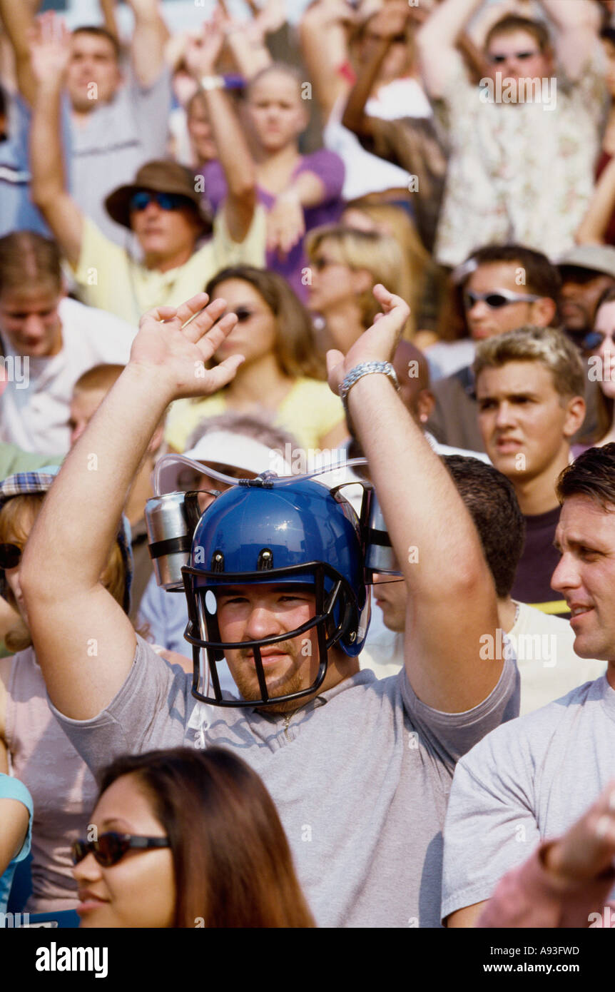 Spectator wearing a football helmet and cheering Stock Photo - Alamy
