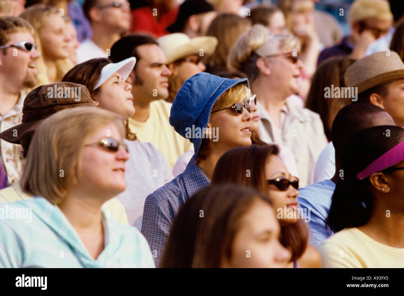 Spectators sitting in a stadium watching with anticipation Stock Photo ...