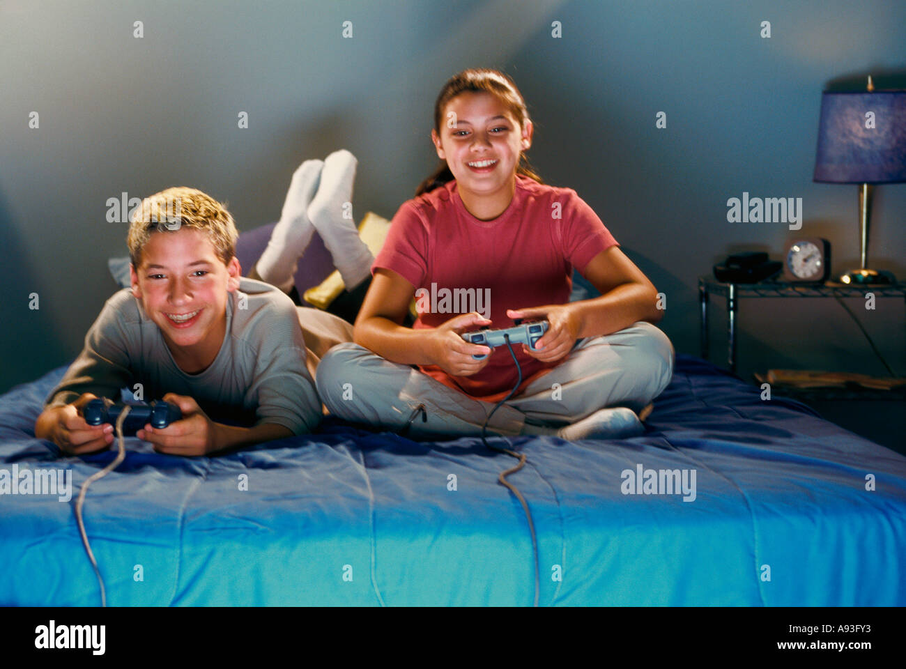 Brother and sister playing video games Stock Photo - Alamy