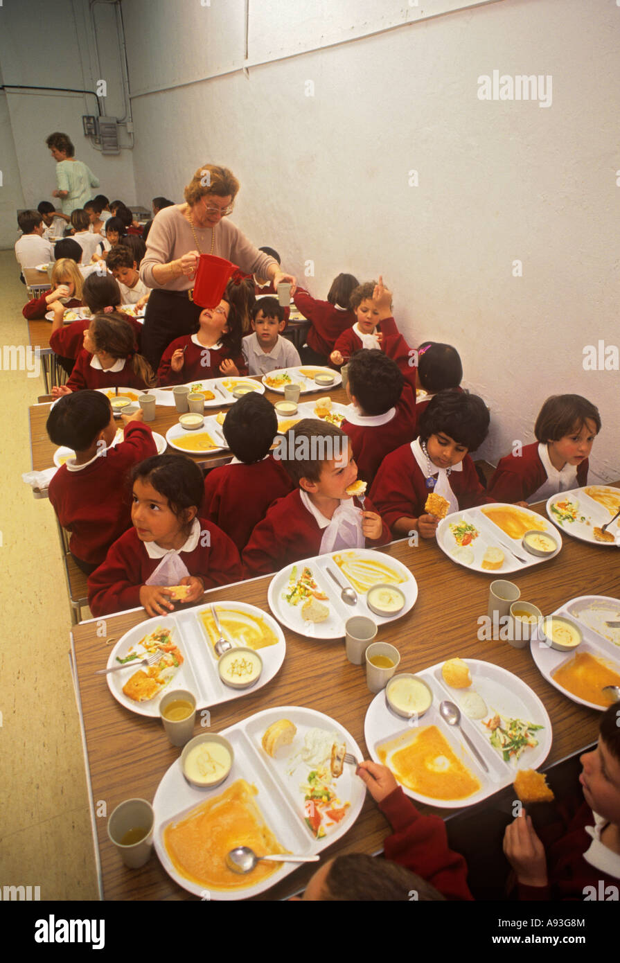 Infant multicultural school children having healthy lunch in school ...