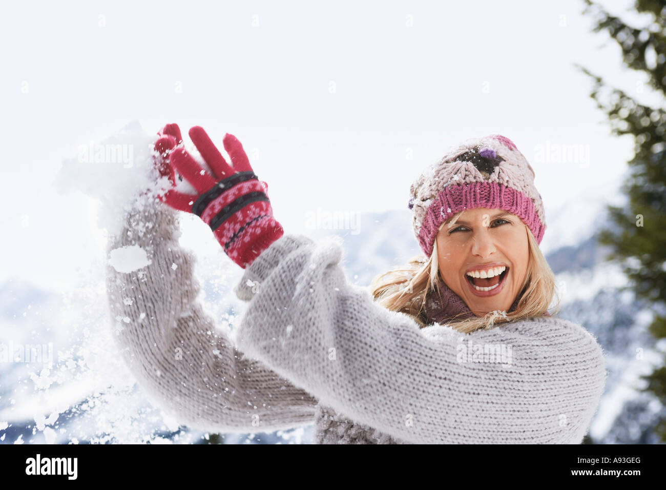 Woman catching snowball Stock Photo - Alamy
