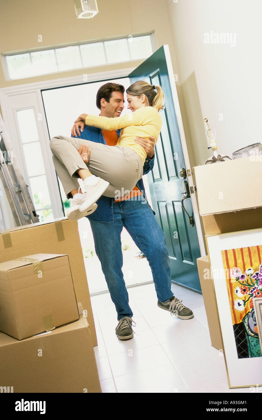 Young man carrying a young woman Stock Photo - Alamy