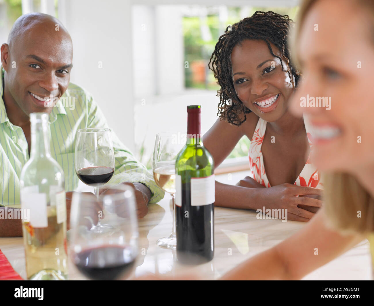 People at table laughing Stock Photo - Alamy