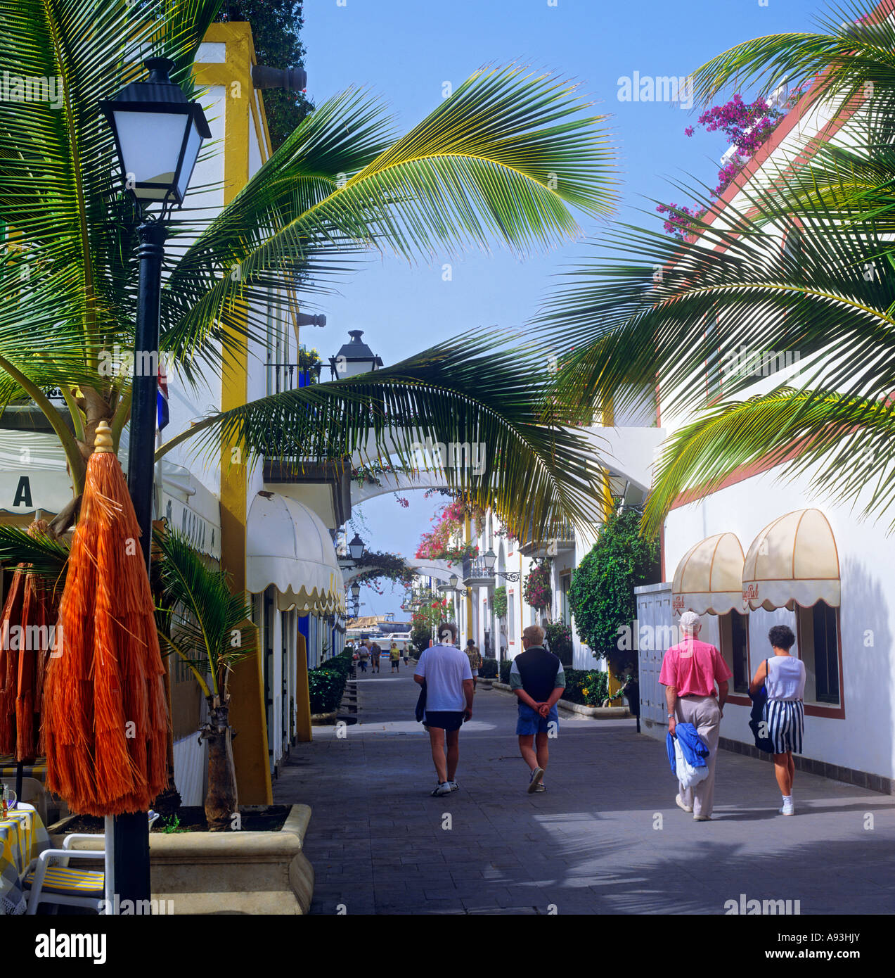 Puerto de Mogan resort with tourists strolling in quiet pedestrian area ...