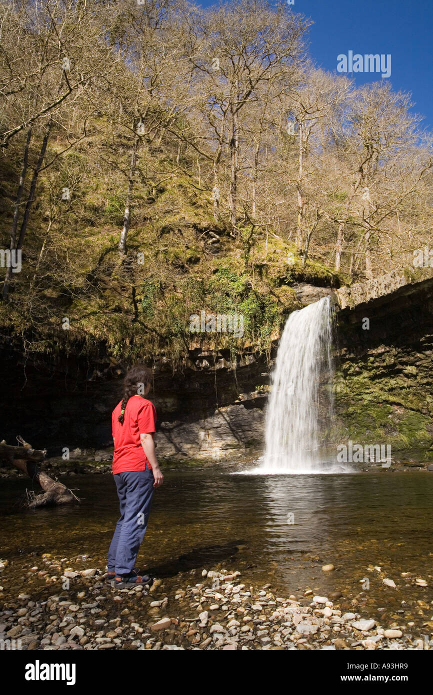 Female looking at Sgwd Gwladys Lady Waterfall Brecon beacons national ...