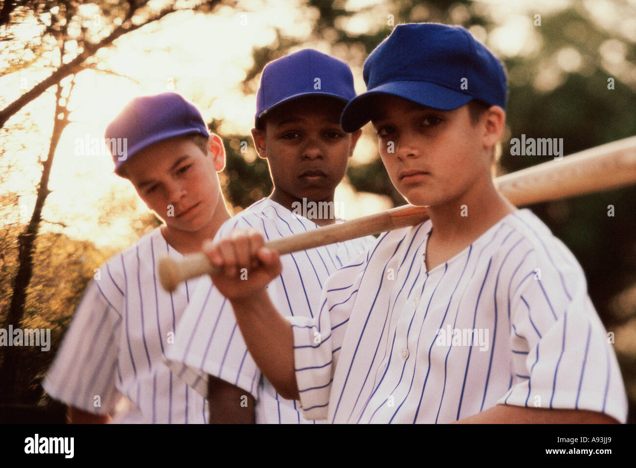 Portrait of three baseball players with a baseball bat Stock Photo - Alamy