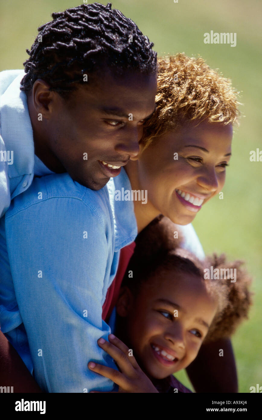 Side profile of parents and their daughter smiling Stock Photo - Alamy