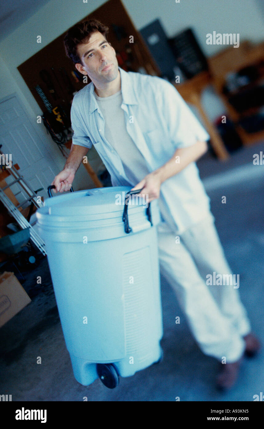 Man carrying a trash bin hi-res stock photography and images - Alamy