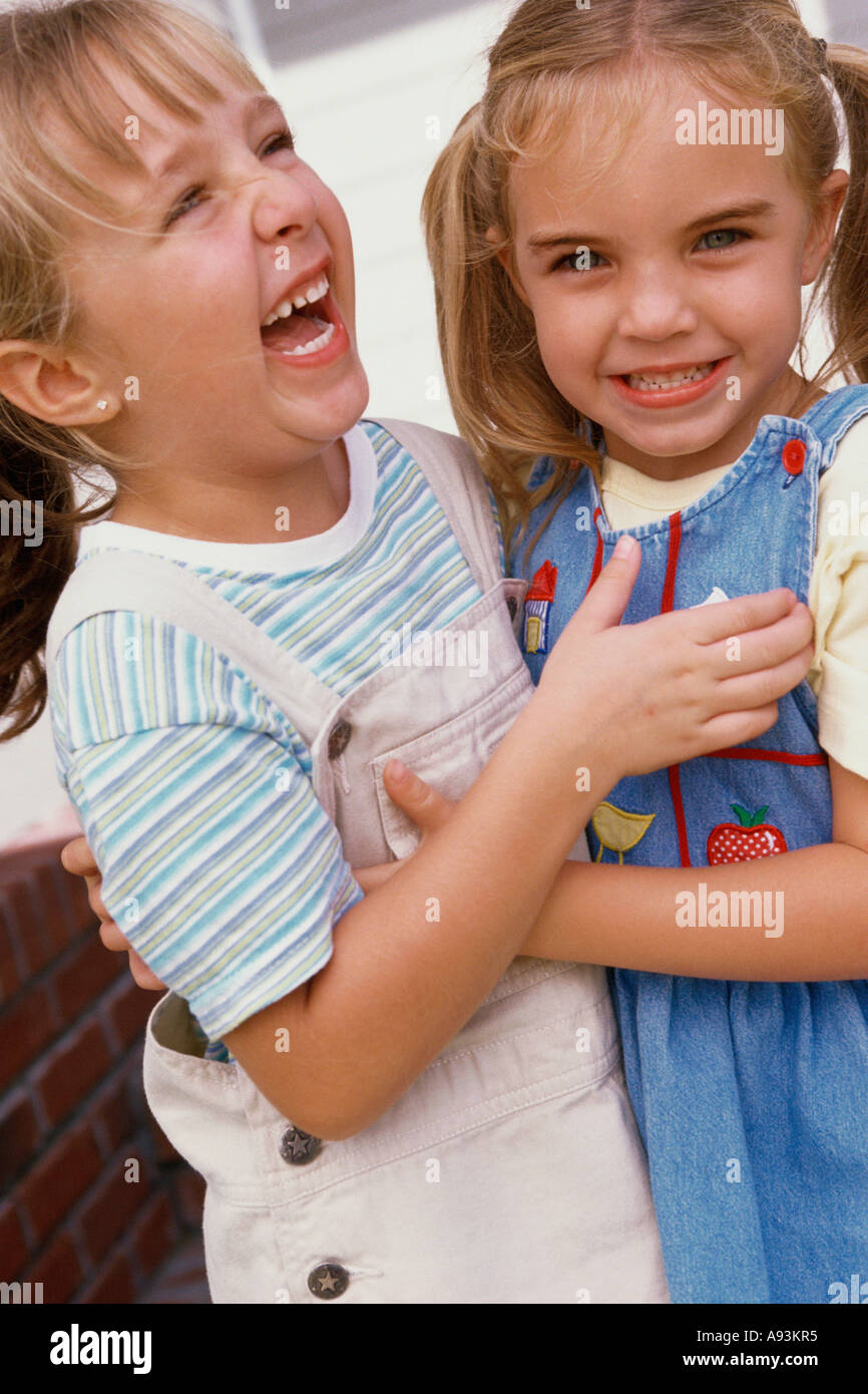 Close-up of two girls hugging each other Stock Photo - Alamy