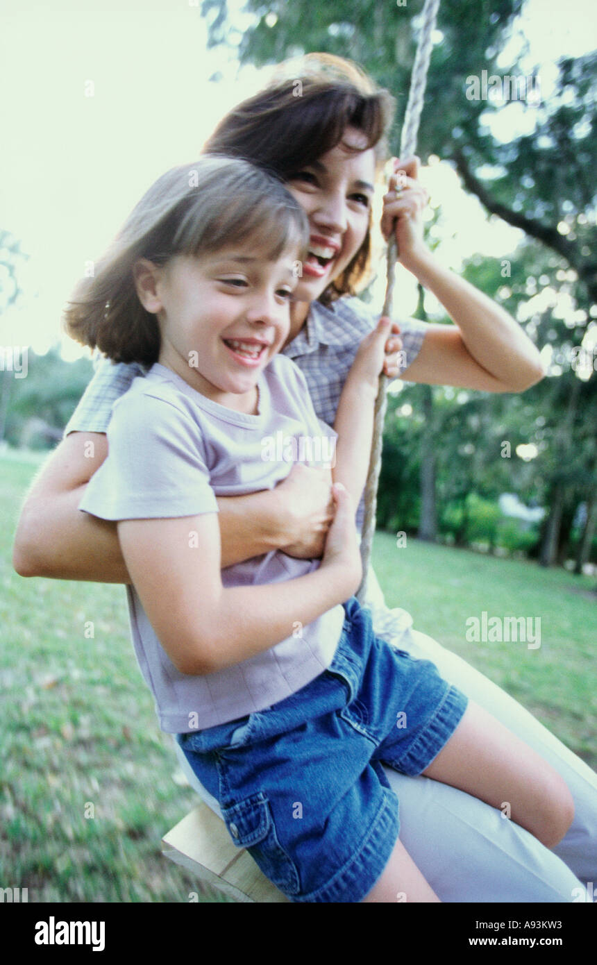 Mother and daughter swinging on a swing Stock Photo - Alamy