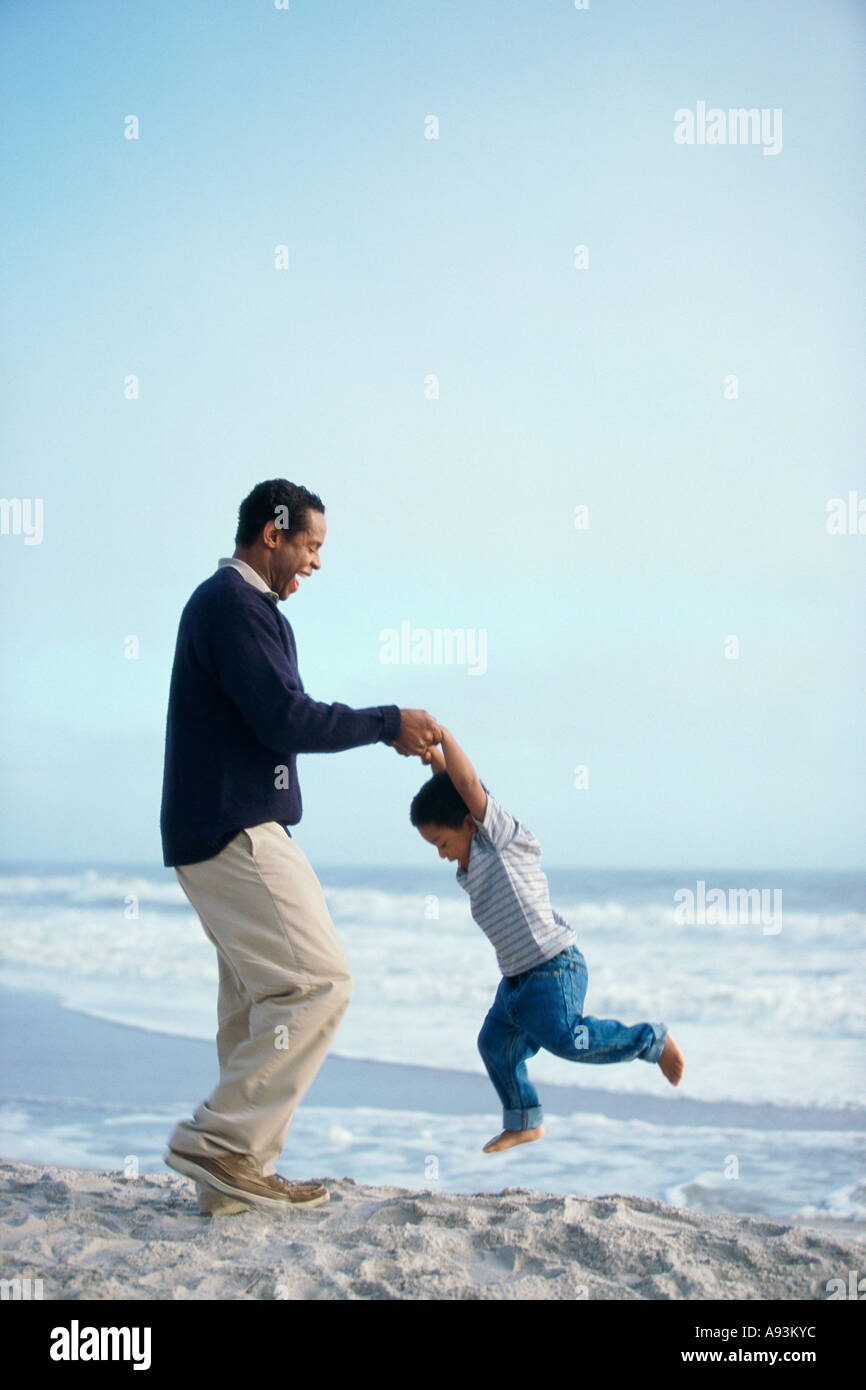 Side profile of a father and his son playing hi-res stock photography ...