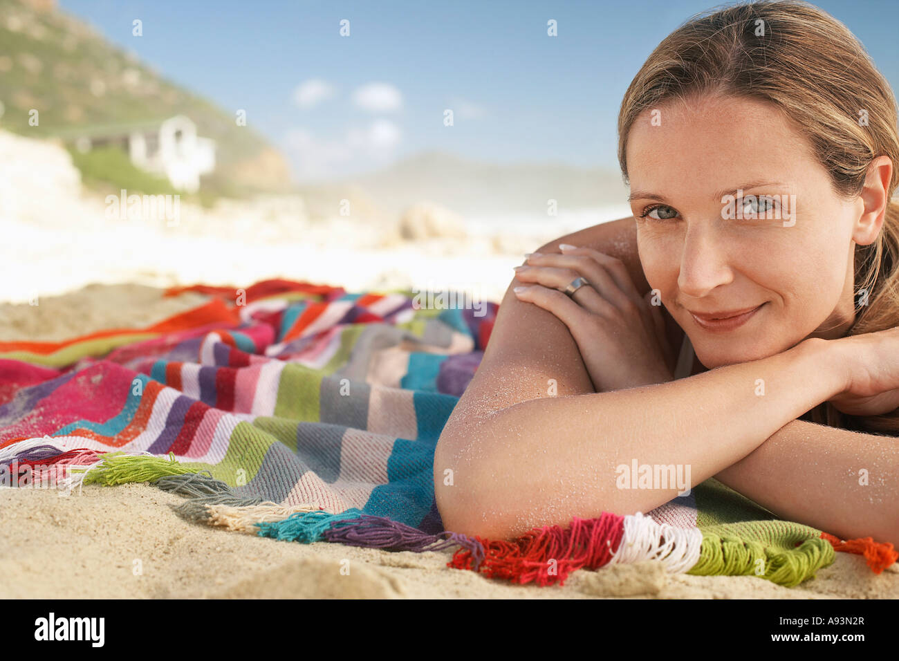 Woman lying on beach, portrait Stock Photo - Alamy