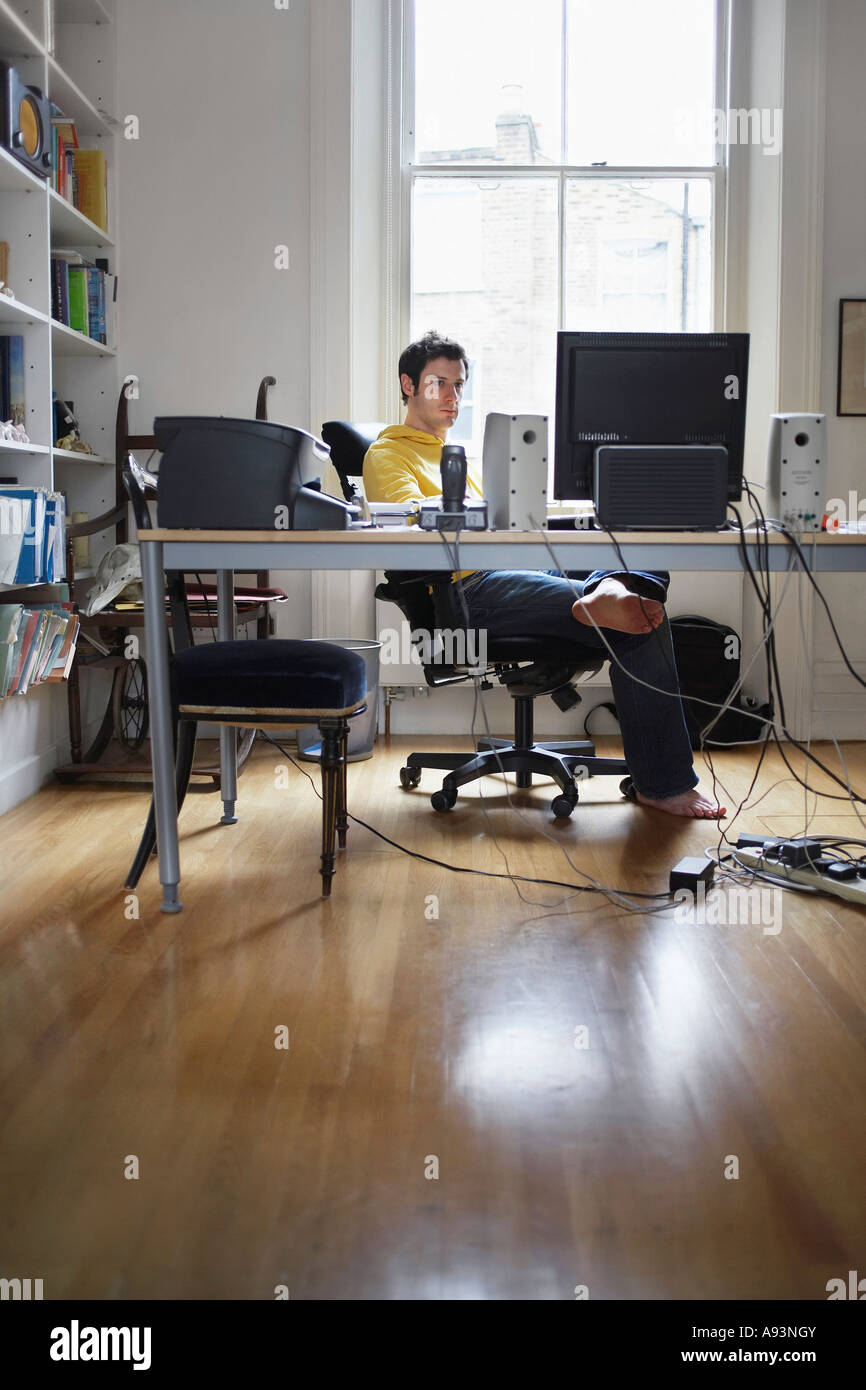Man working on computer at home Stock Photo - Alamy