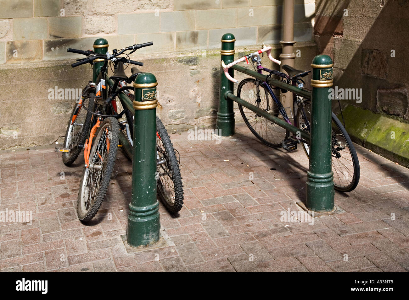 Bicycles chained to rack Hereford England UK Stock Photo - Alamy