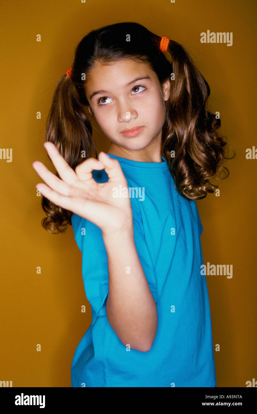 Side profile of a girl making an ok sign Stock Photo - Alamy