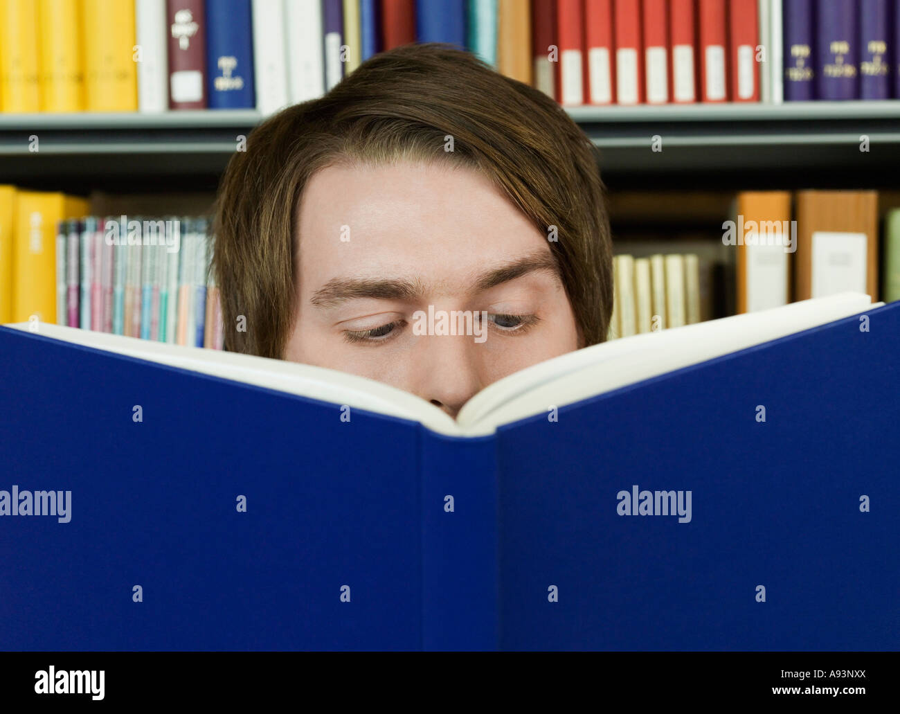 Young man reading Stock Photo - Alamy