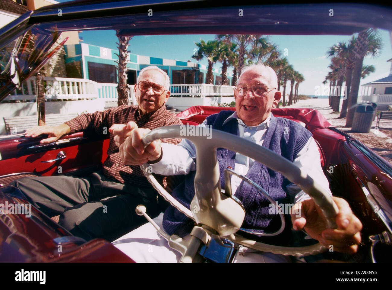 Two senior men sitting in a convertible car Stock Photo - Alamy