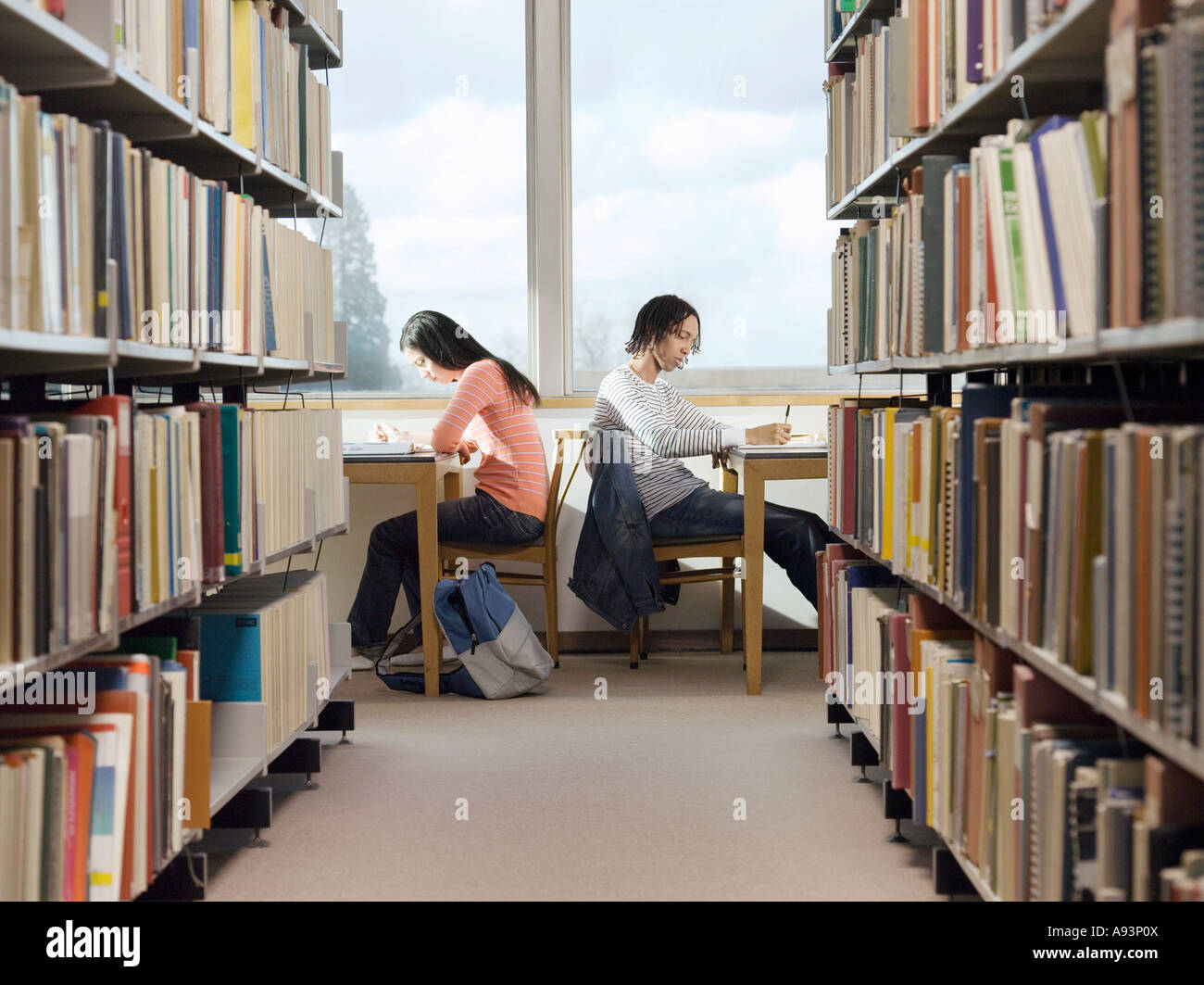 Teenagers doing homework in library Stock Photo - Alamy