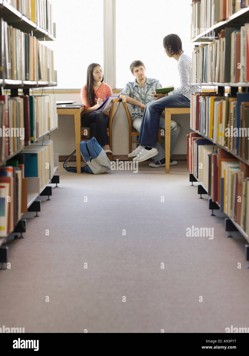 Teenagers doing homework in library Stock Photo - Alamy