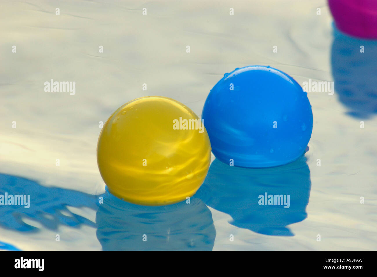 Multicolored balls in the water Stock Photo - Alamy