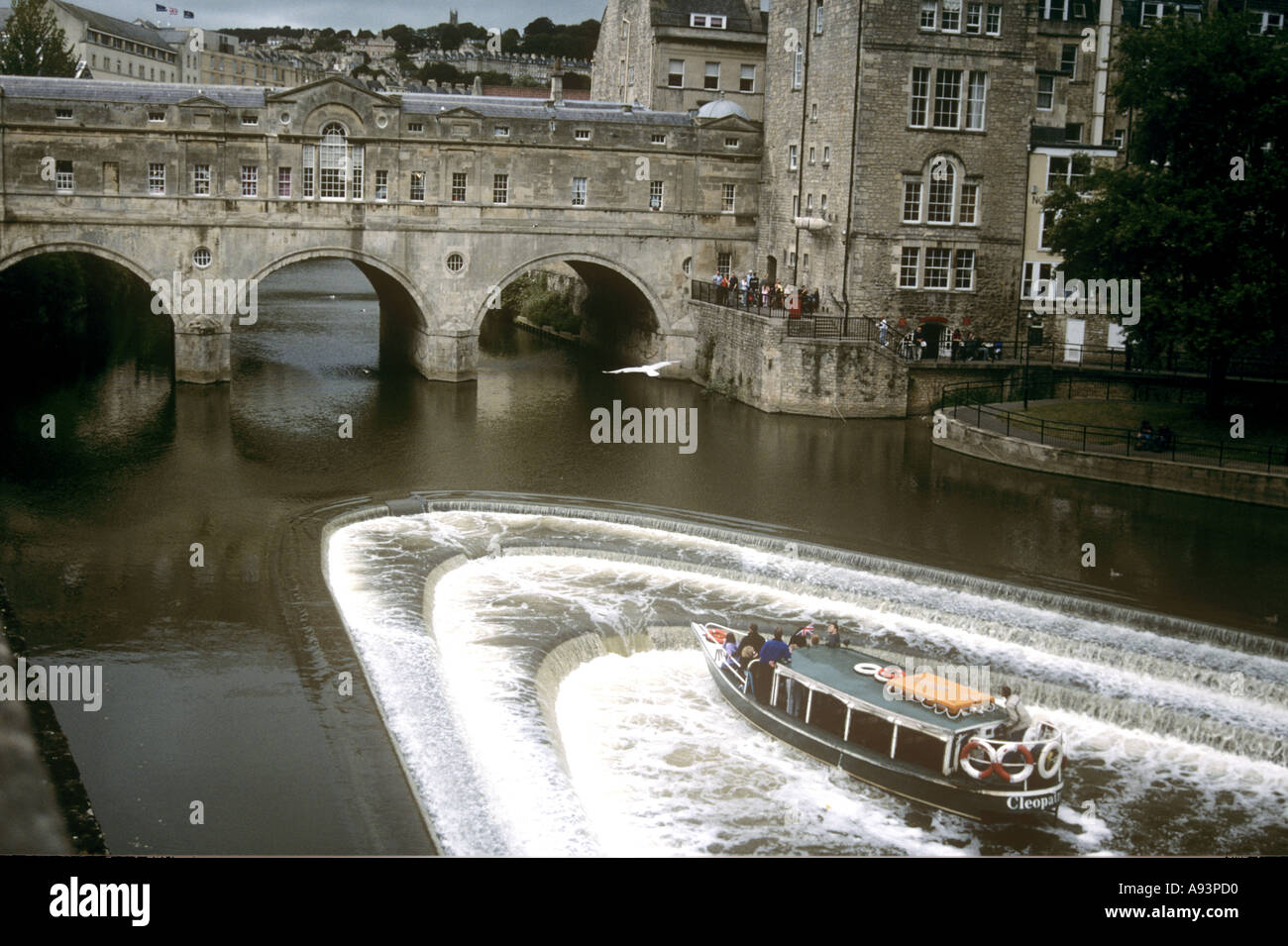 Cleopatra tour boat approaches weirs on river Avon next to Pulteney ...