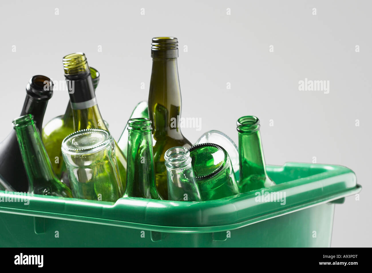 Empty bottles in green container, close-up Stock Photo - Alamy