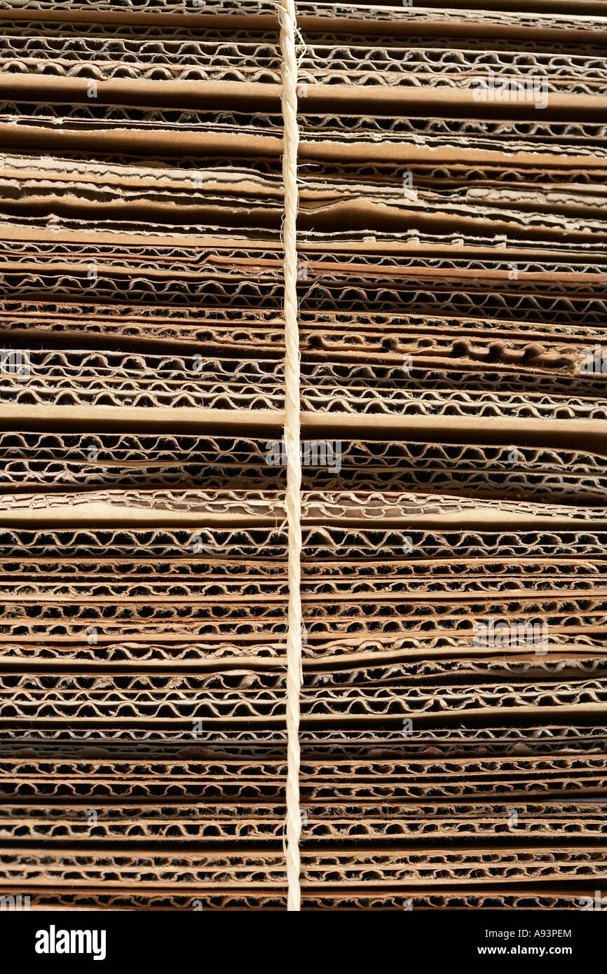 Bundle of corrugated cardboard tied with string, close-up, full frame ...
