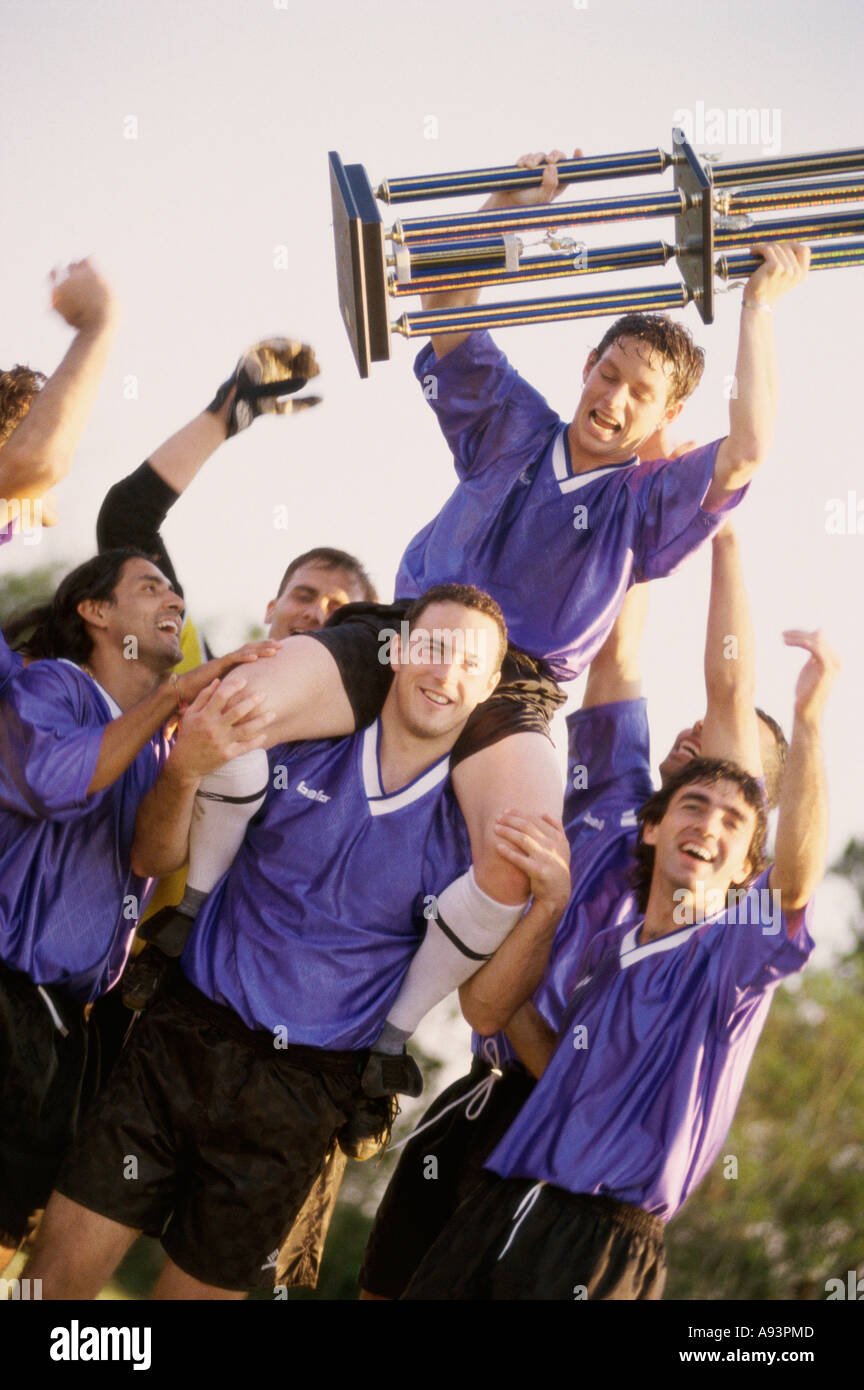 Holding trophy smiling looking away winning achievement hi-res stock ...