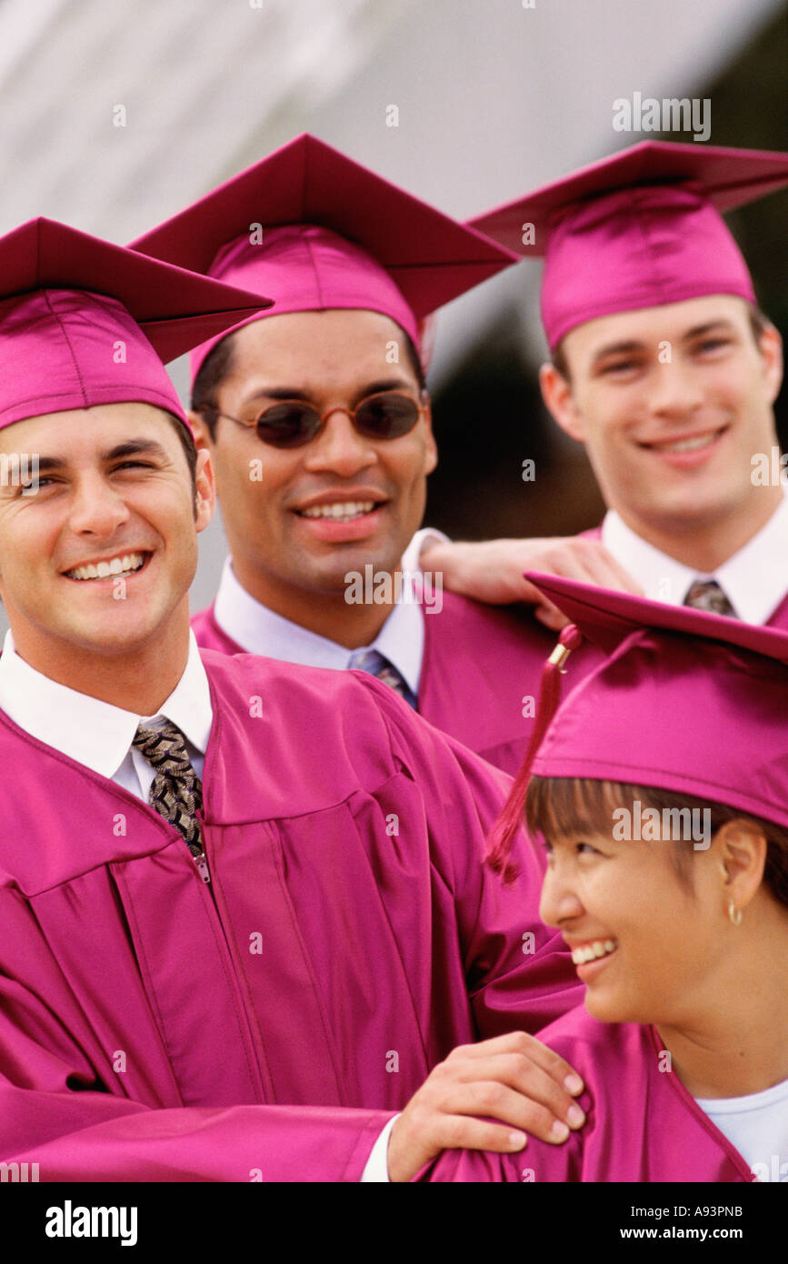 Four young graduates smiling Stock Photo - Alamy