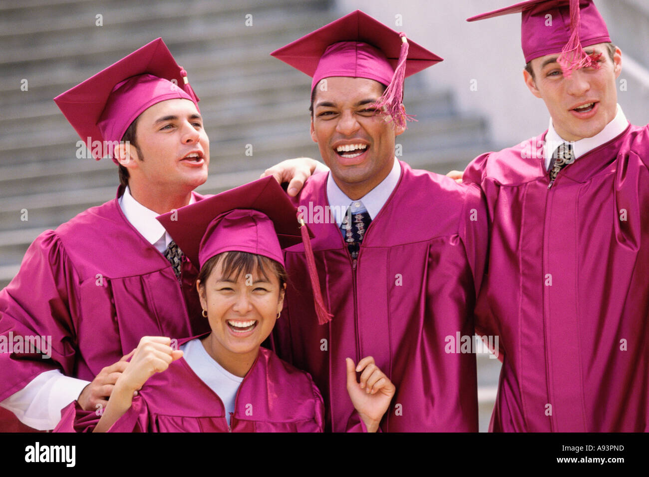 Close-up of four young graduates smiling Stock Photo - Alamy