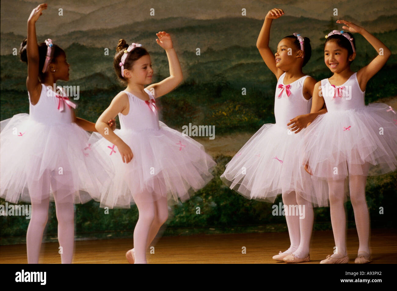 Four ballet dancers dancing with their hands raised Stock Photo - Alamy