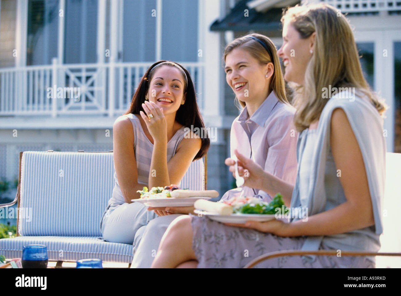 Close-up of three young women eating together Stock Photo - Alamy