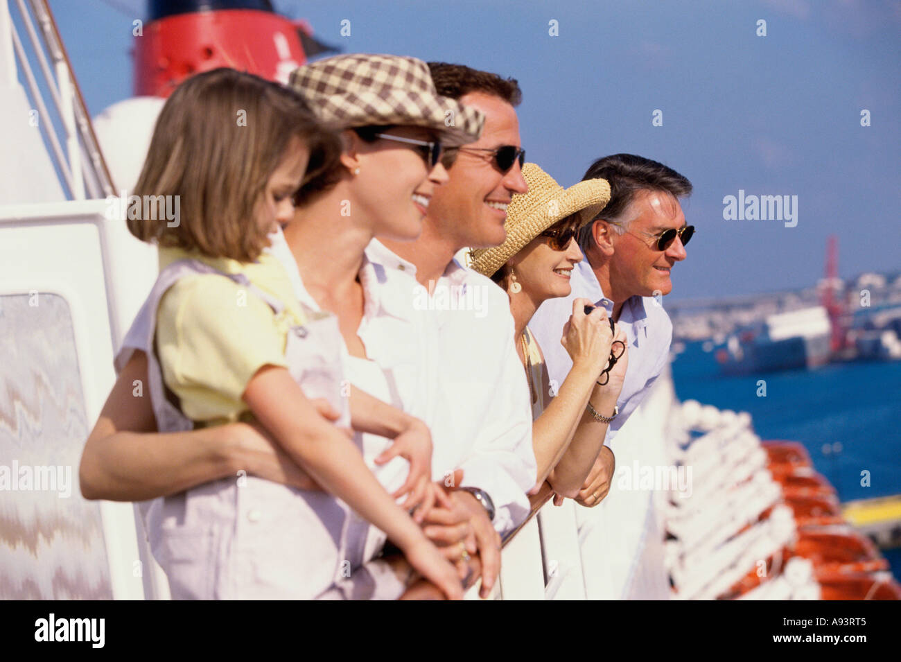 Side profile of five people standing on the deck of a cruise ship ...