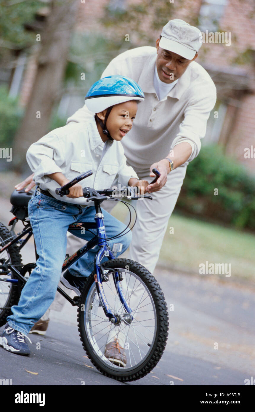 Grandfather teaching his grandson ride a bicycle Stock Photo - Alamy