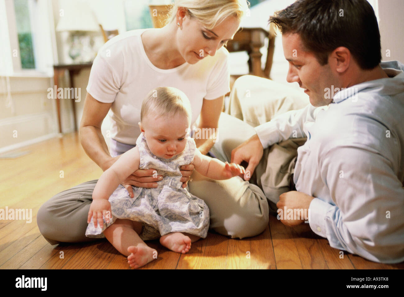 Parents looking at their daughter smiling Stock Photo - Alamy