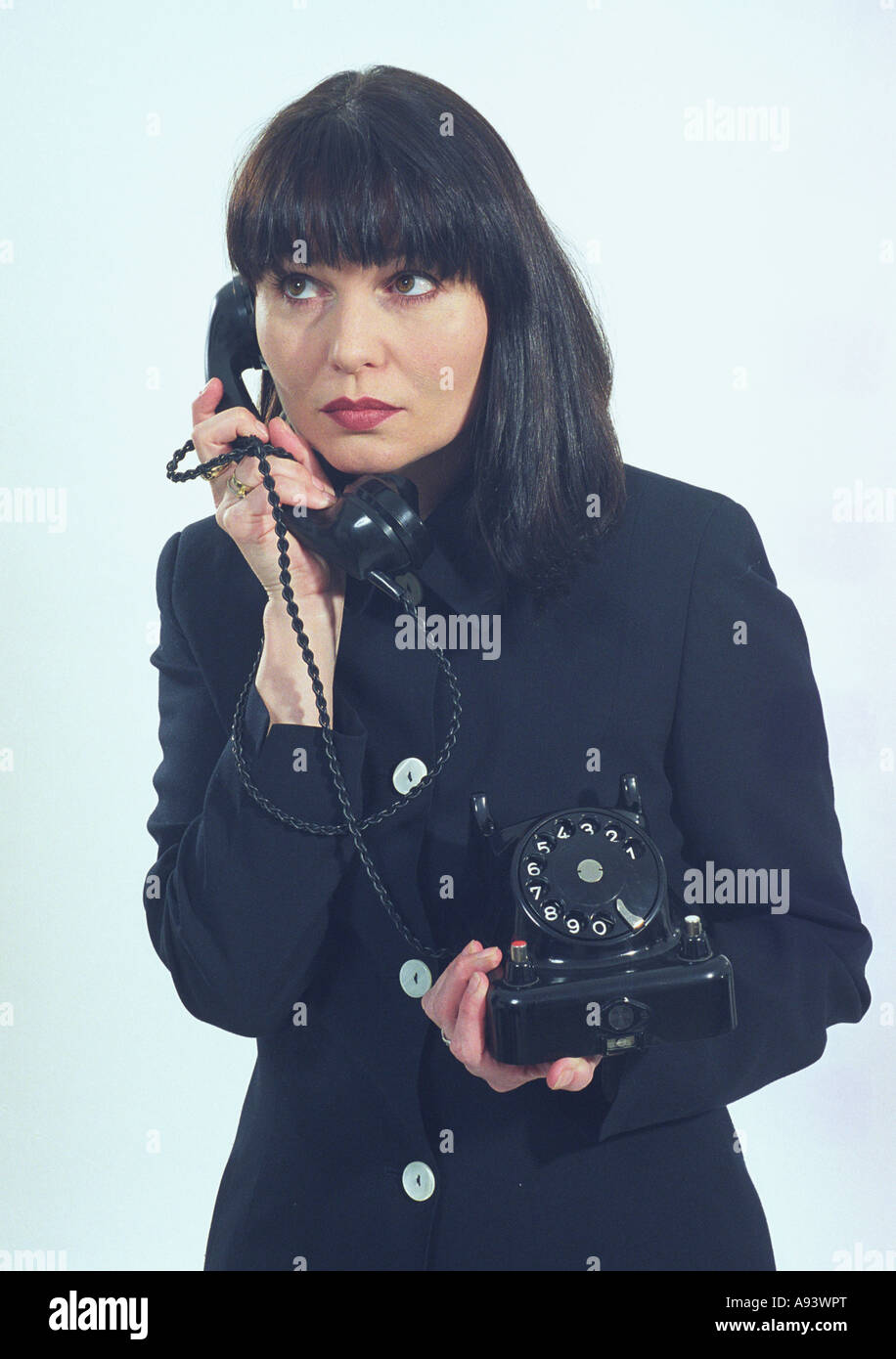 Woman telephones with an old telephone Stock Photo - Alamy