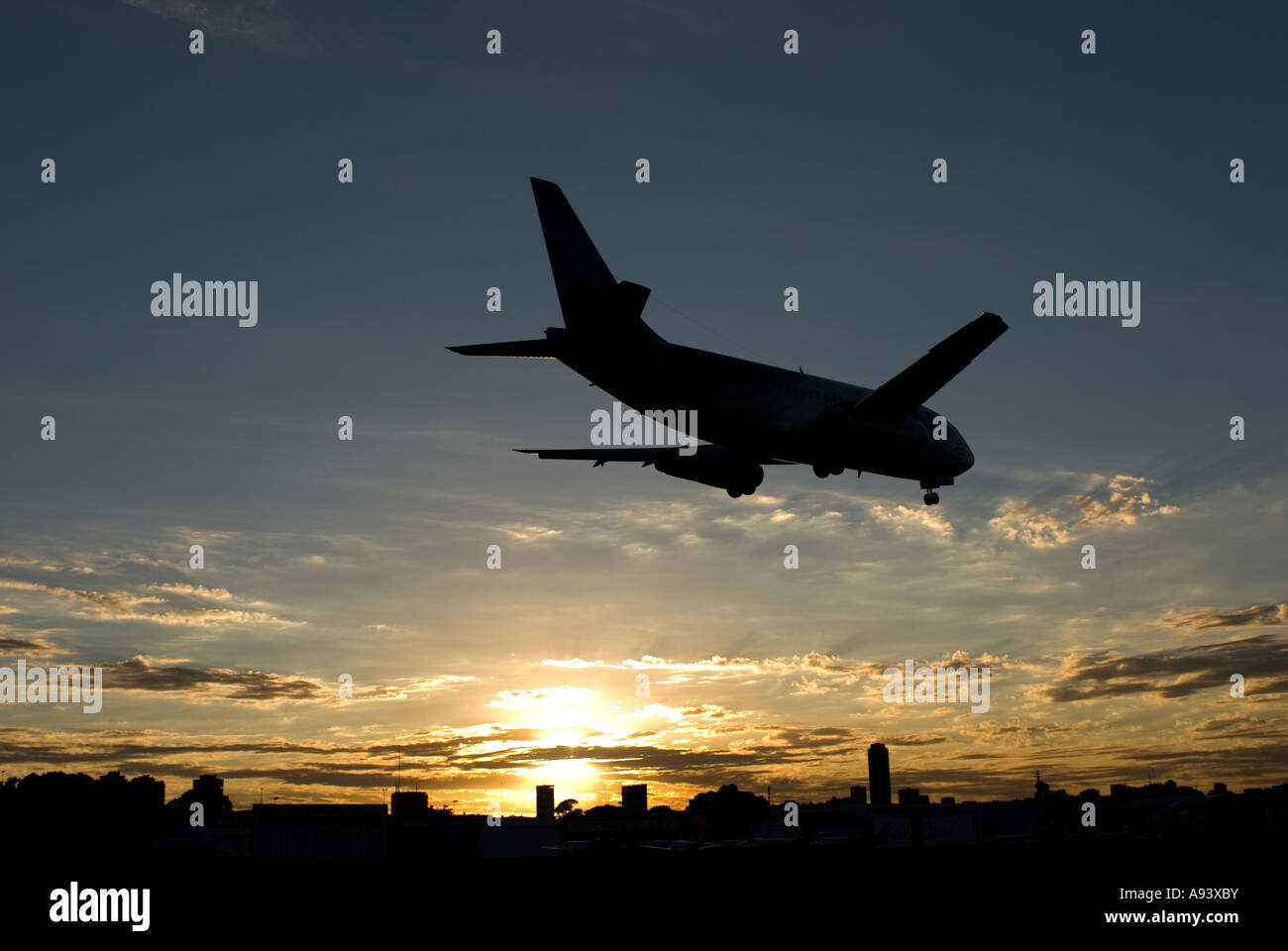 Jet Airplane Landing at Sunset Stock Photo - Alamy
