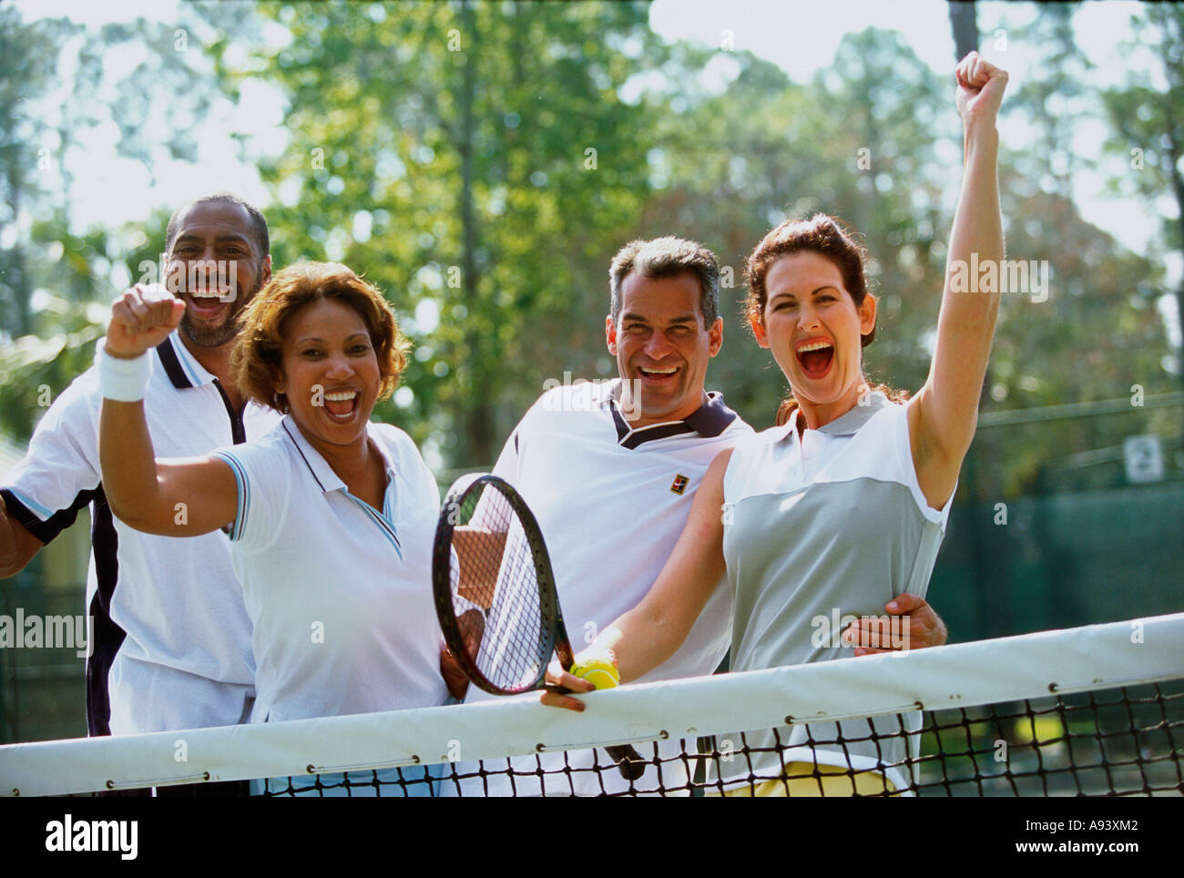 Portrait of two mid adult couples cheering Stock Photo - Alamy